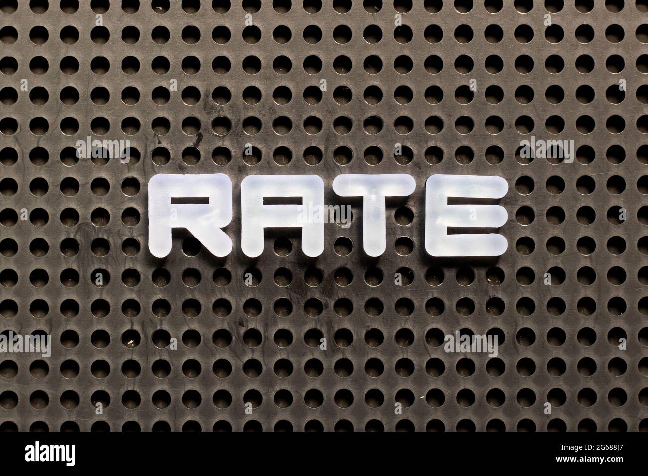 White color letter in word rate on black pegboard background Stock ...