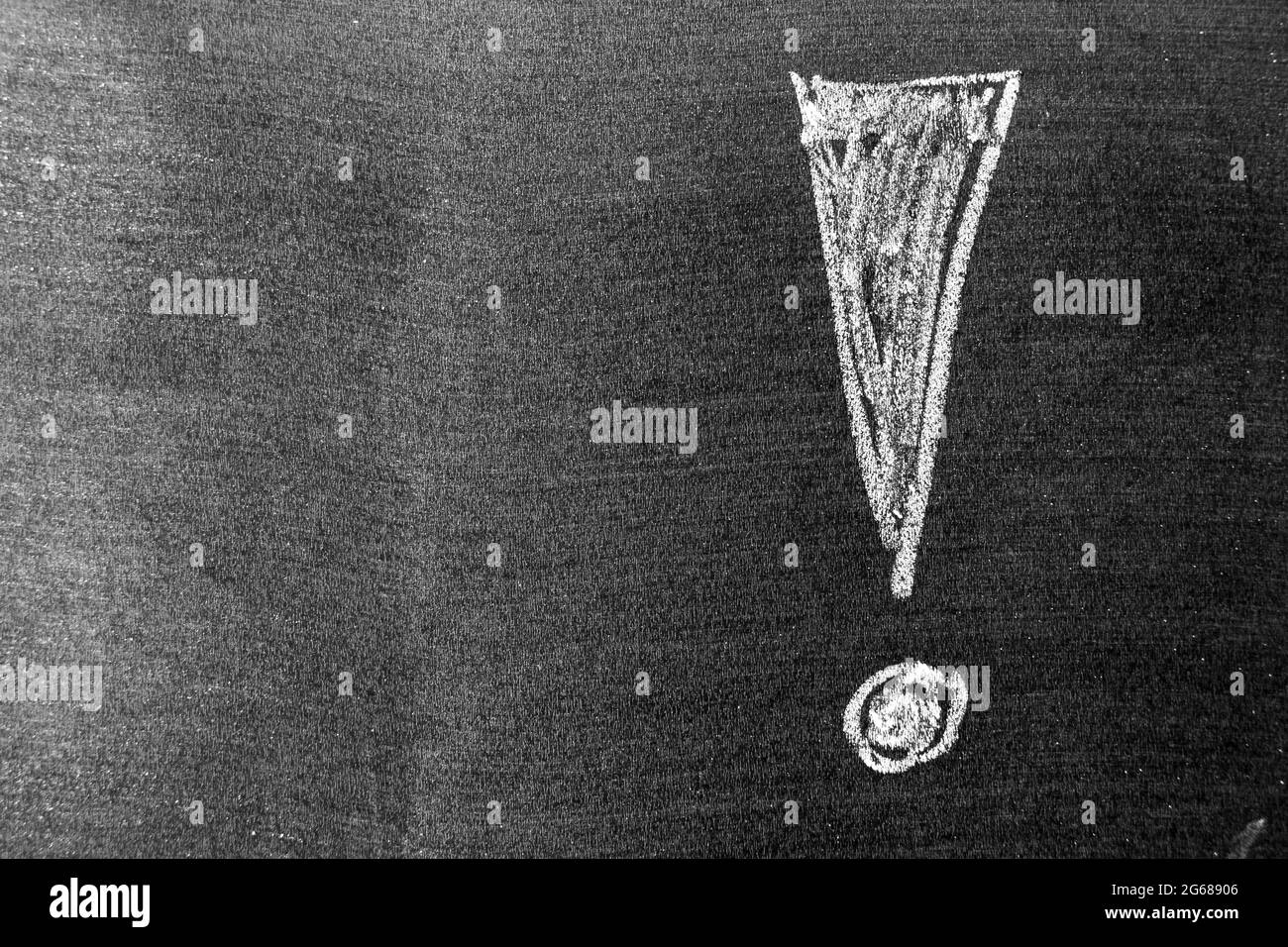 White color chalk hand drawing in exclamation mark with blank space ...