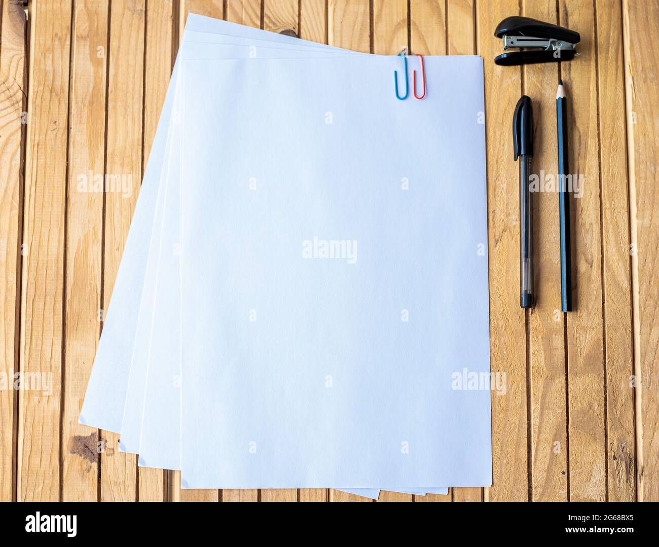 Empty Paper Clipped Together Lying Flat On A Table With Pencils And ...