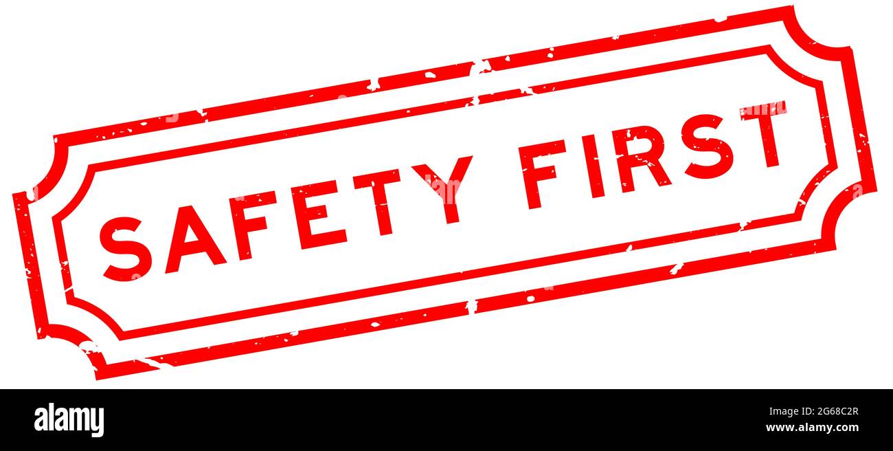 Grunge red safety first word rubber seal stamp on white background ...