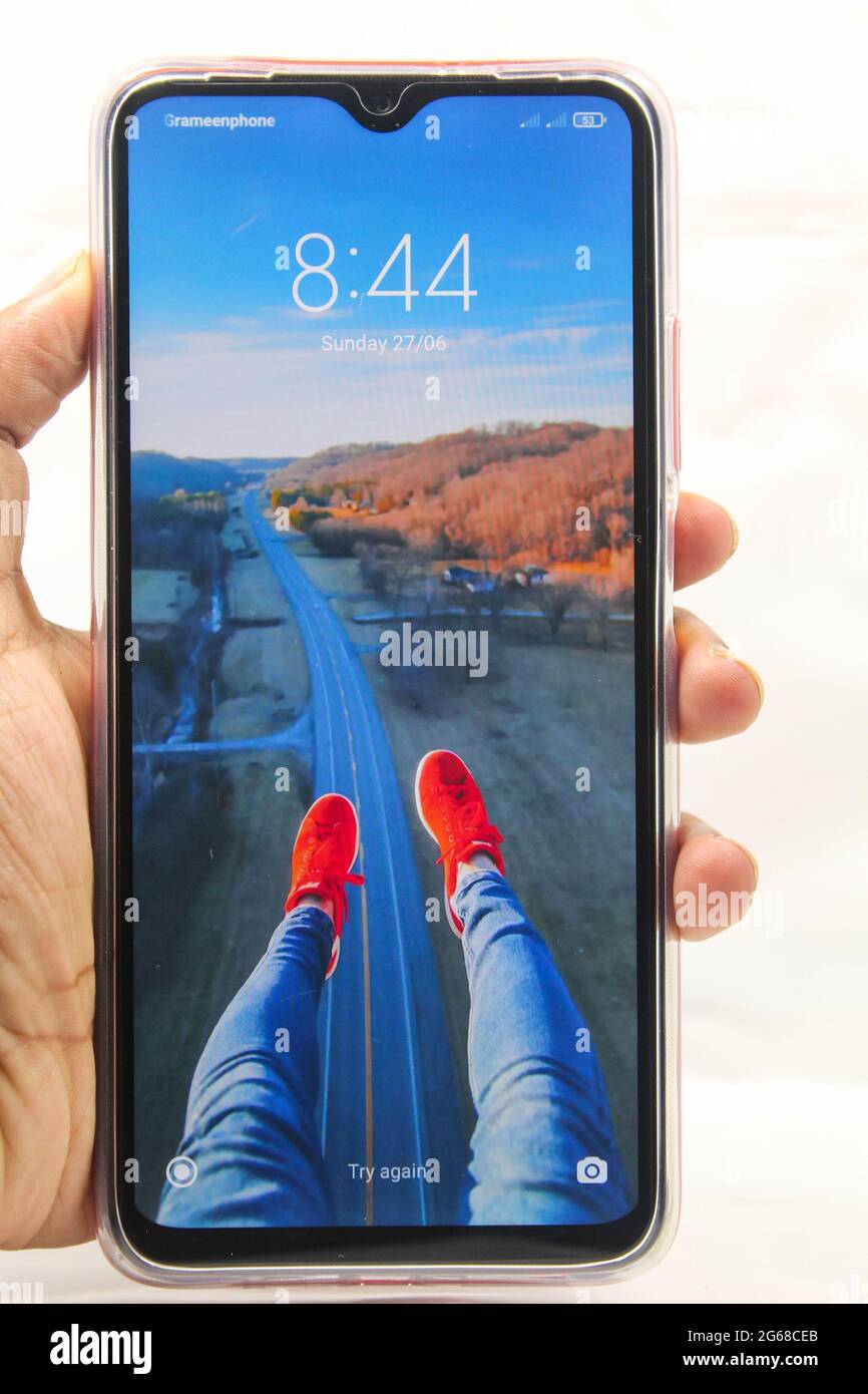 A hand scrolling a smartphone Stock Photo - Alamy