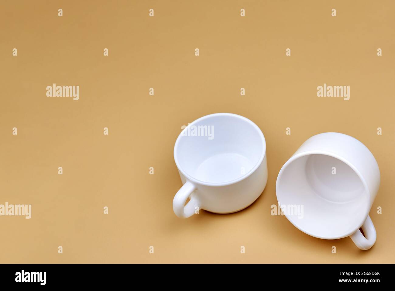 Two clean empty coffee or tea cups on a beige background Stock Photo ...