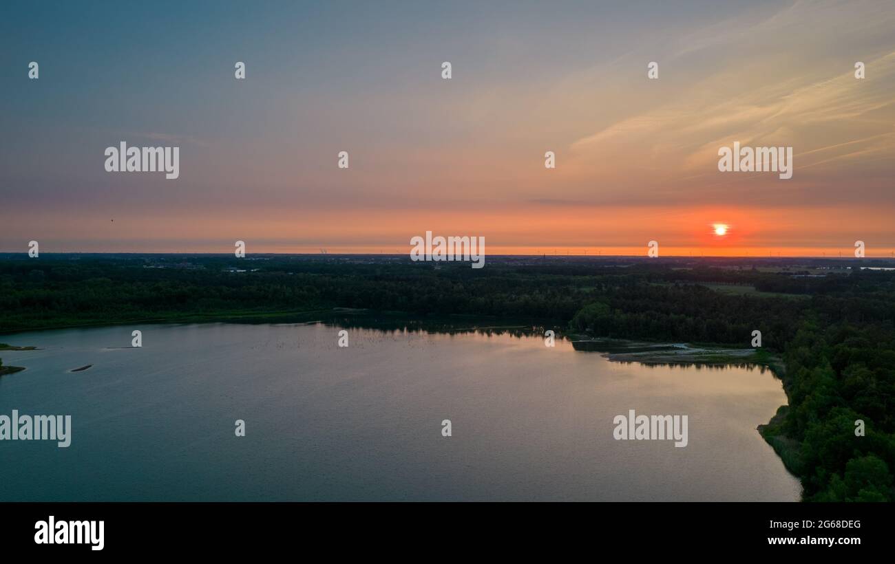 Aerial view taken with a drone of the red sky sunset at twilight over ...