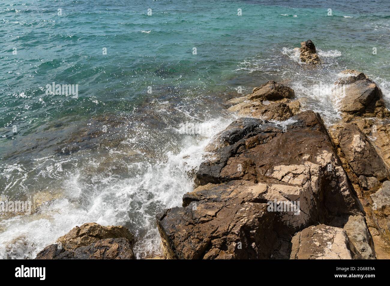 A photo of the blurry sea waves crashing on the rocky shore of the ...
