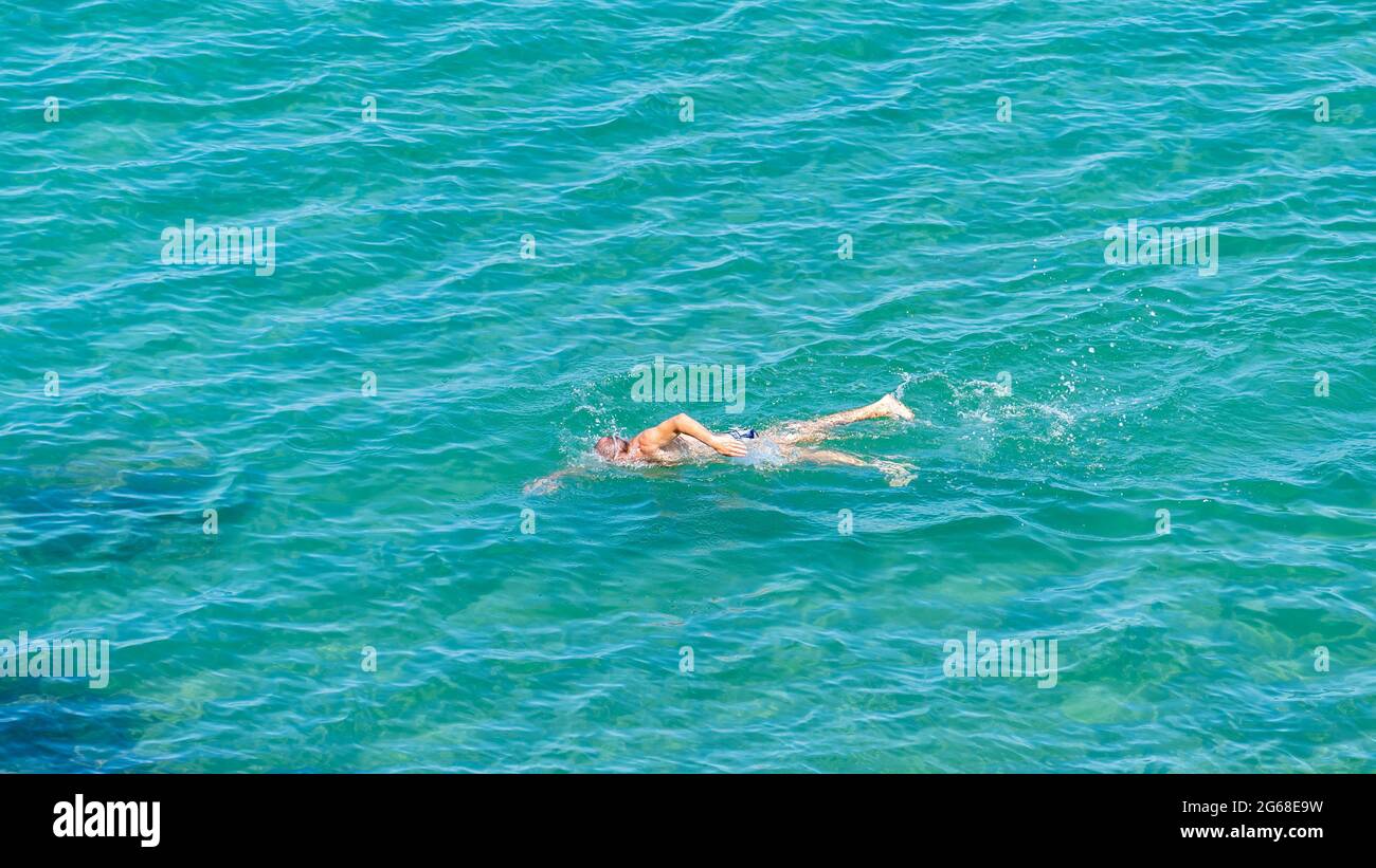 Water surface with a floating man Stock Photo - Alamy