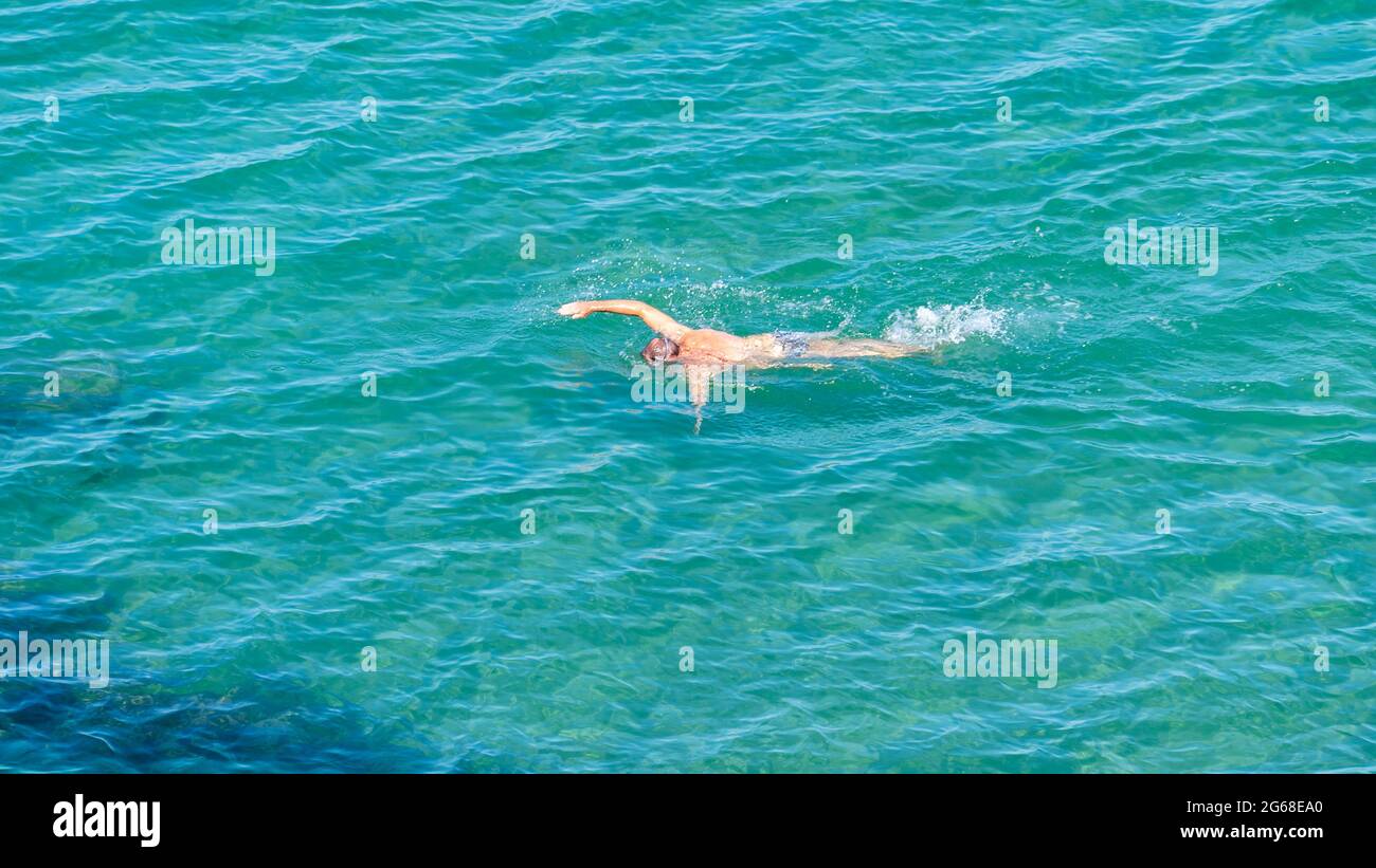 Water surface with a floating man Stock Photo - Alamy