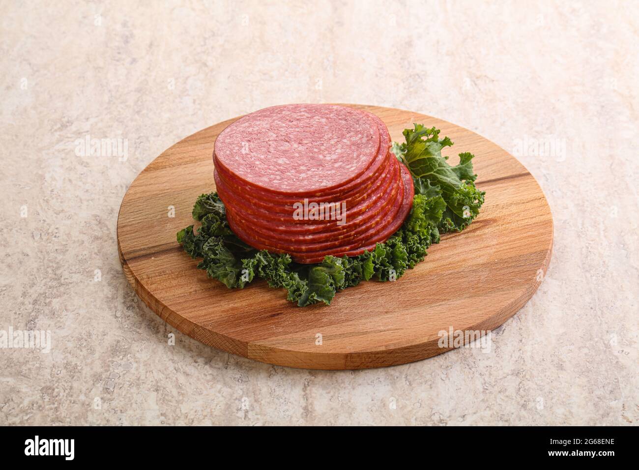 Sliced salami pork sausage snack over board Stock Photo - Alamy