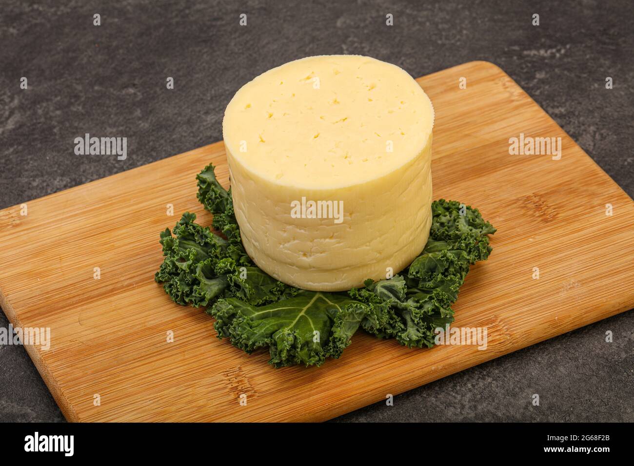 Yellow round dairy soft cheese piece Stock Photo - Alamy