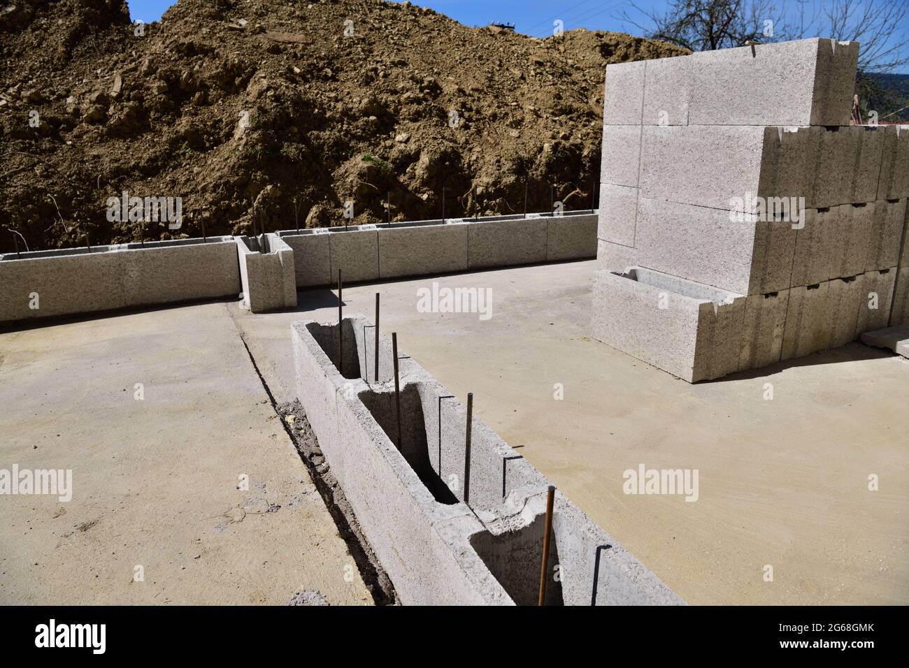 Masonry building foundations of walls near the house with a pile of ...