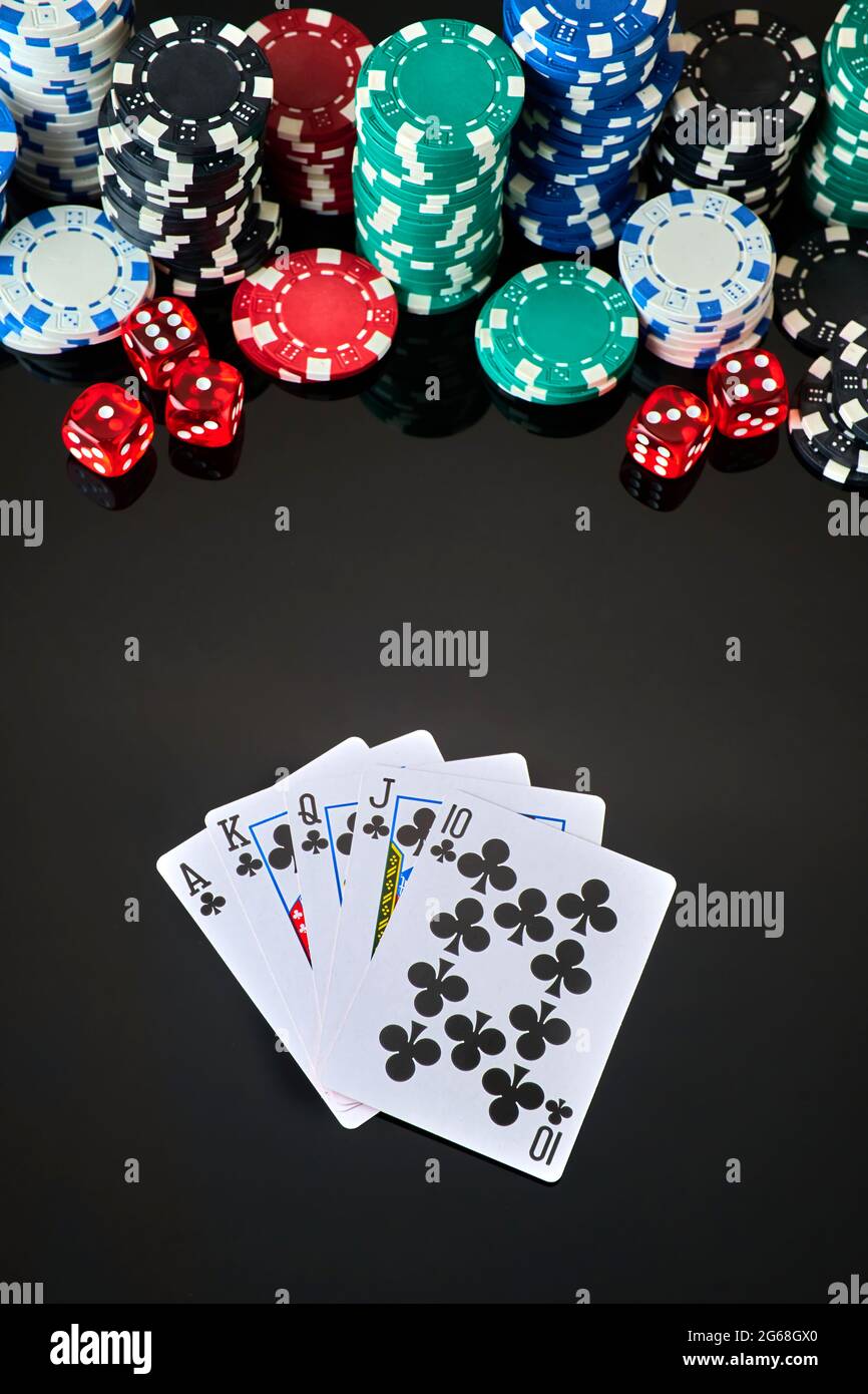Casino chips, playing cards and dices on dark reflective background ...