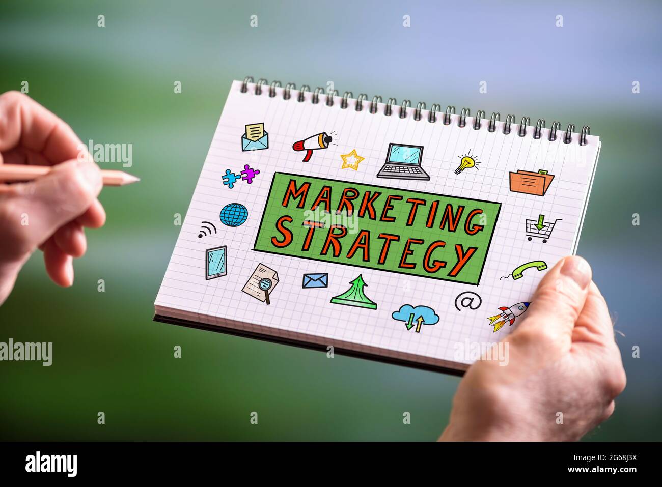 Hand drawing marketing strategy concept on a notepad Stock Photo - Alamy