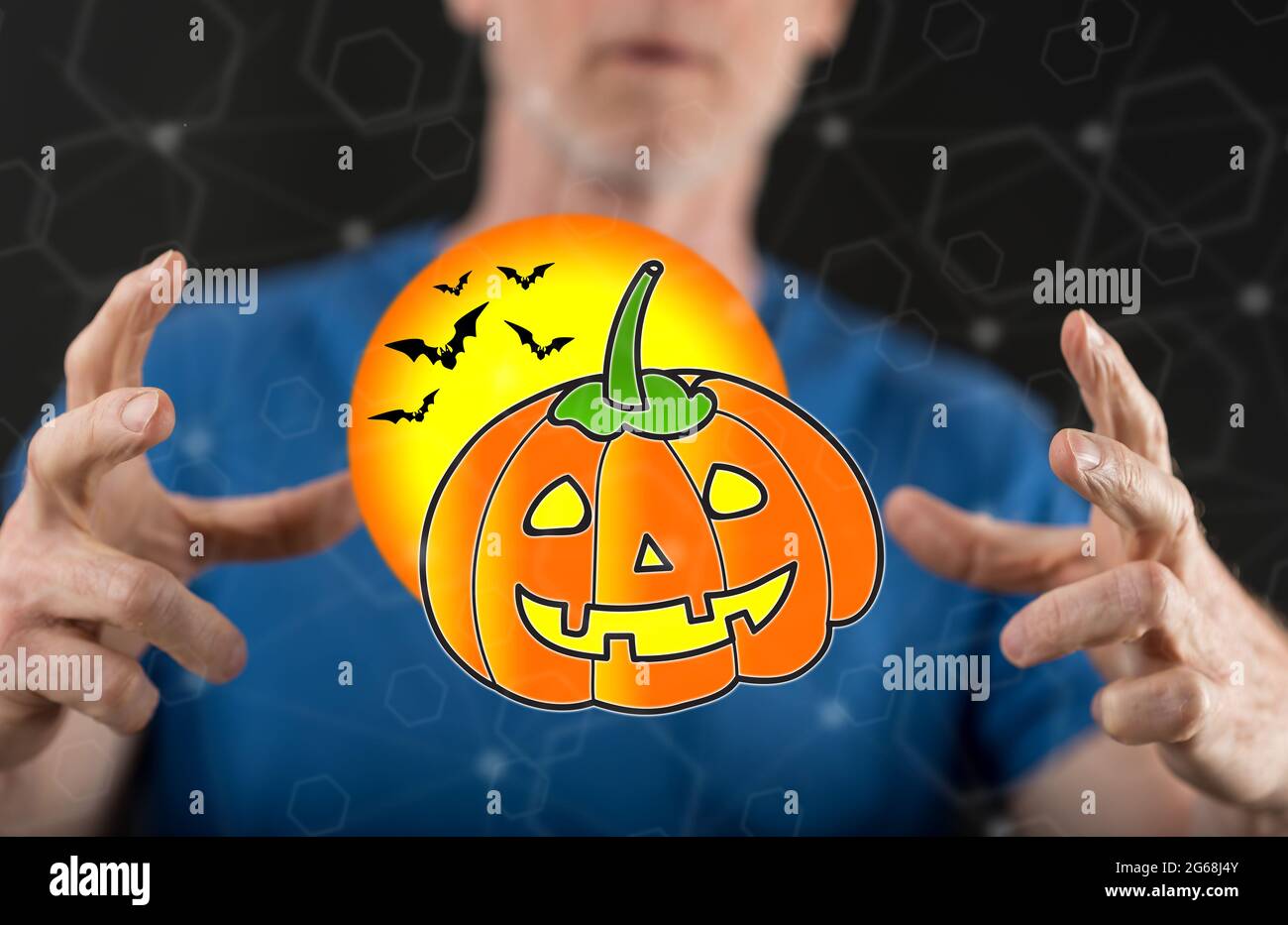 Halloween concept between hands of a man in background Stock Photo - Alamy