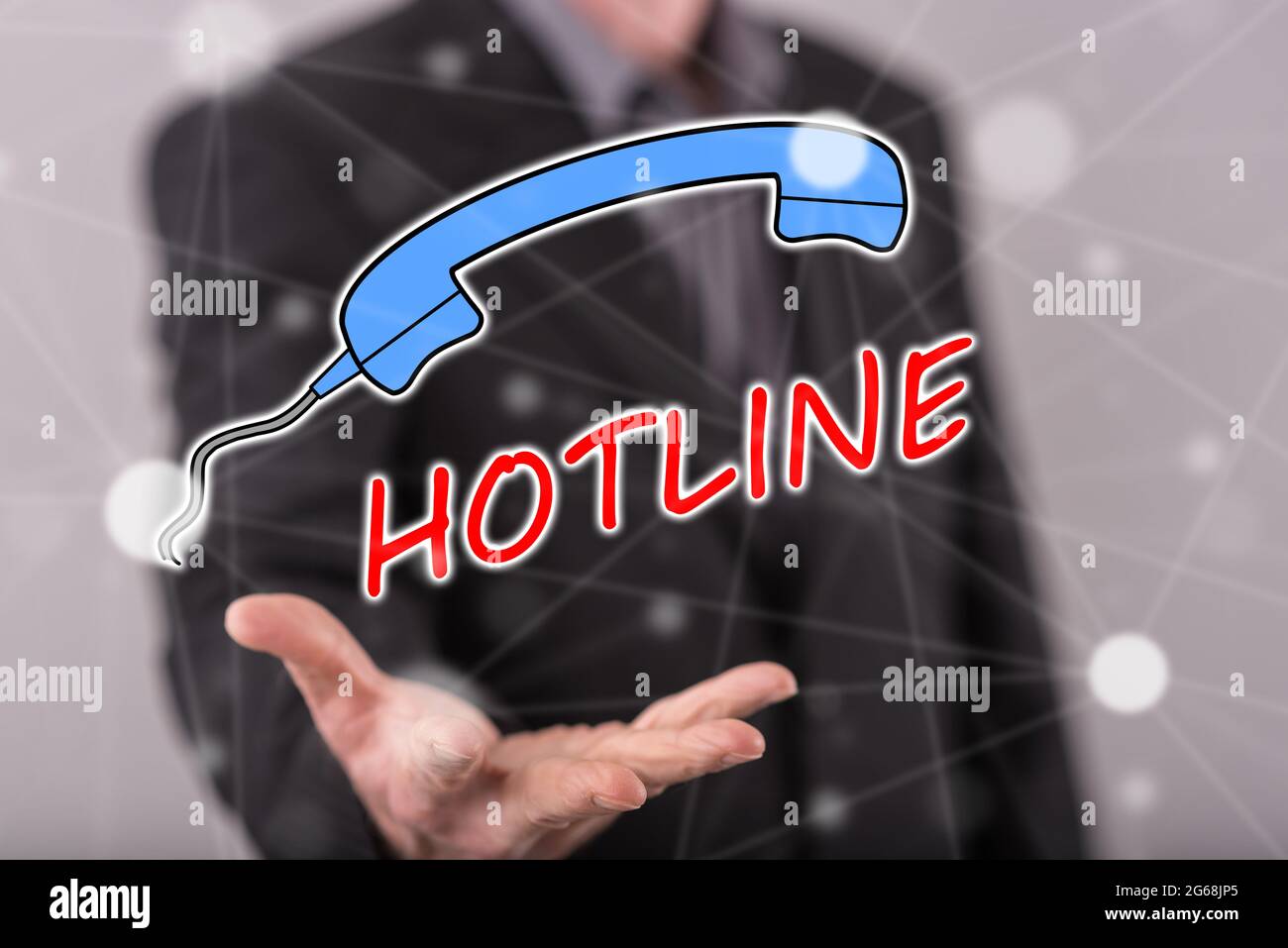 Hotline concept above the hand of a man in background Stock Photo - Alamy
