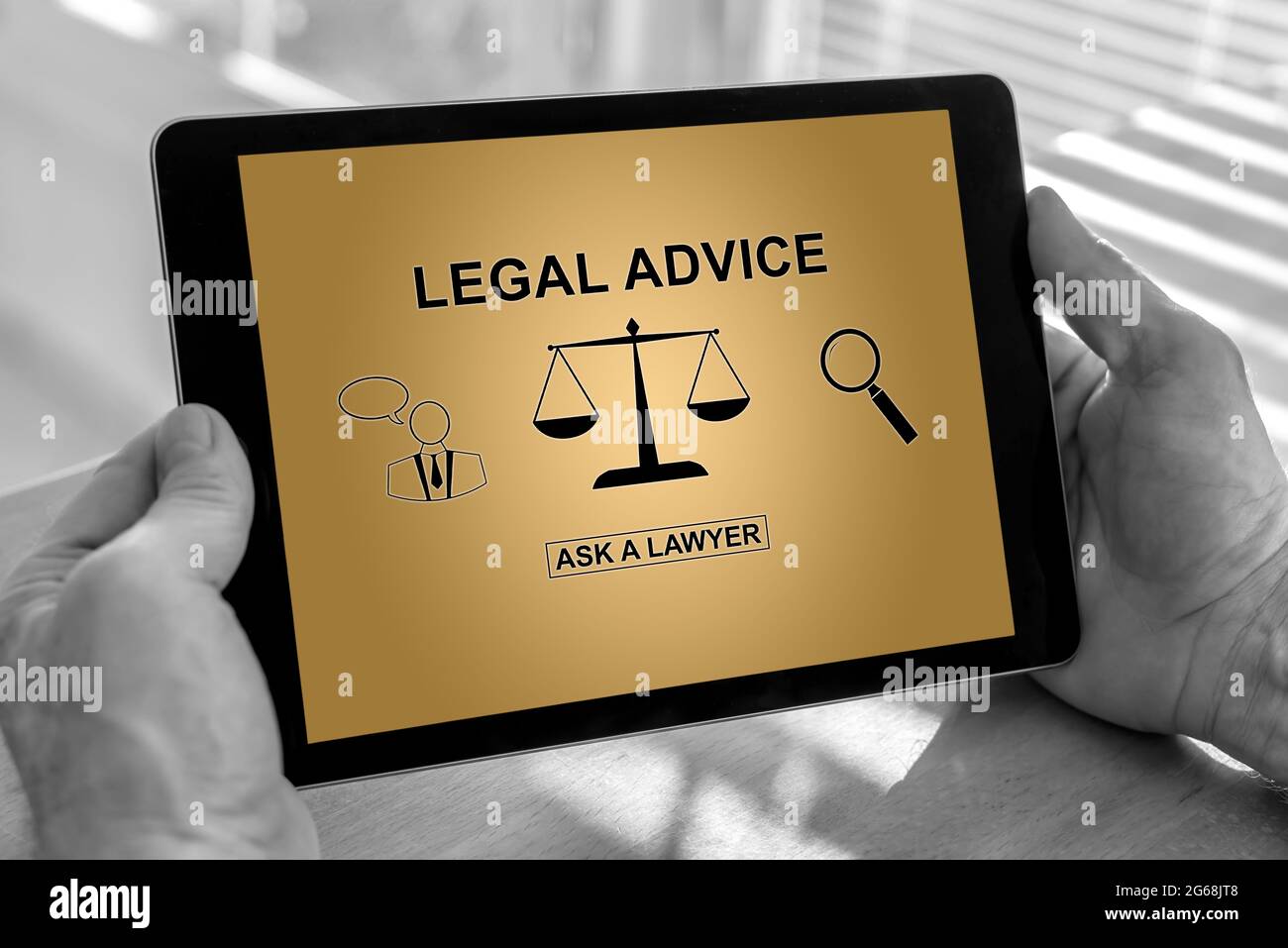 Male hands holding a tablet with legal advice concept Stock Photo - Alamy