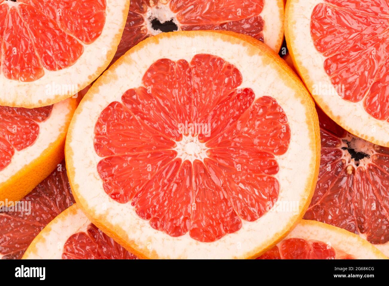Abstract red background with citrus-fruit of grapefruit slices. Close ...