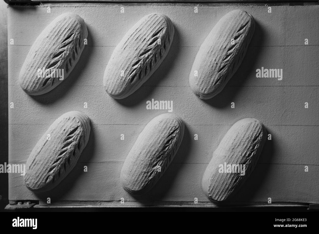 Raw bread. Fresh raw dough in product line Stock Photo - Alamy