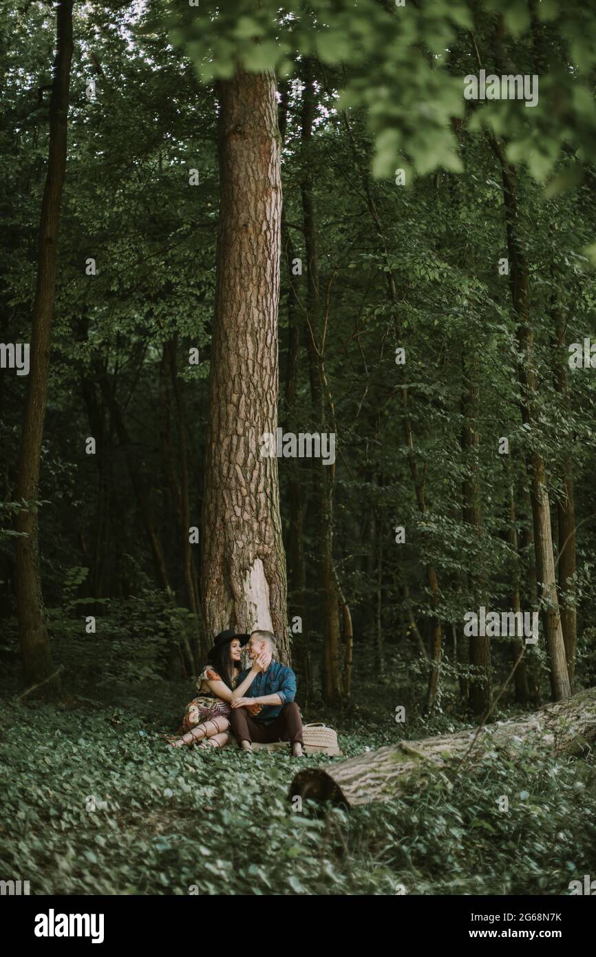 Outdoor full length shot of happy young family, man and woman, enjoying ...