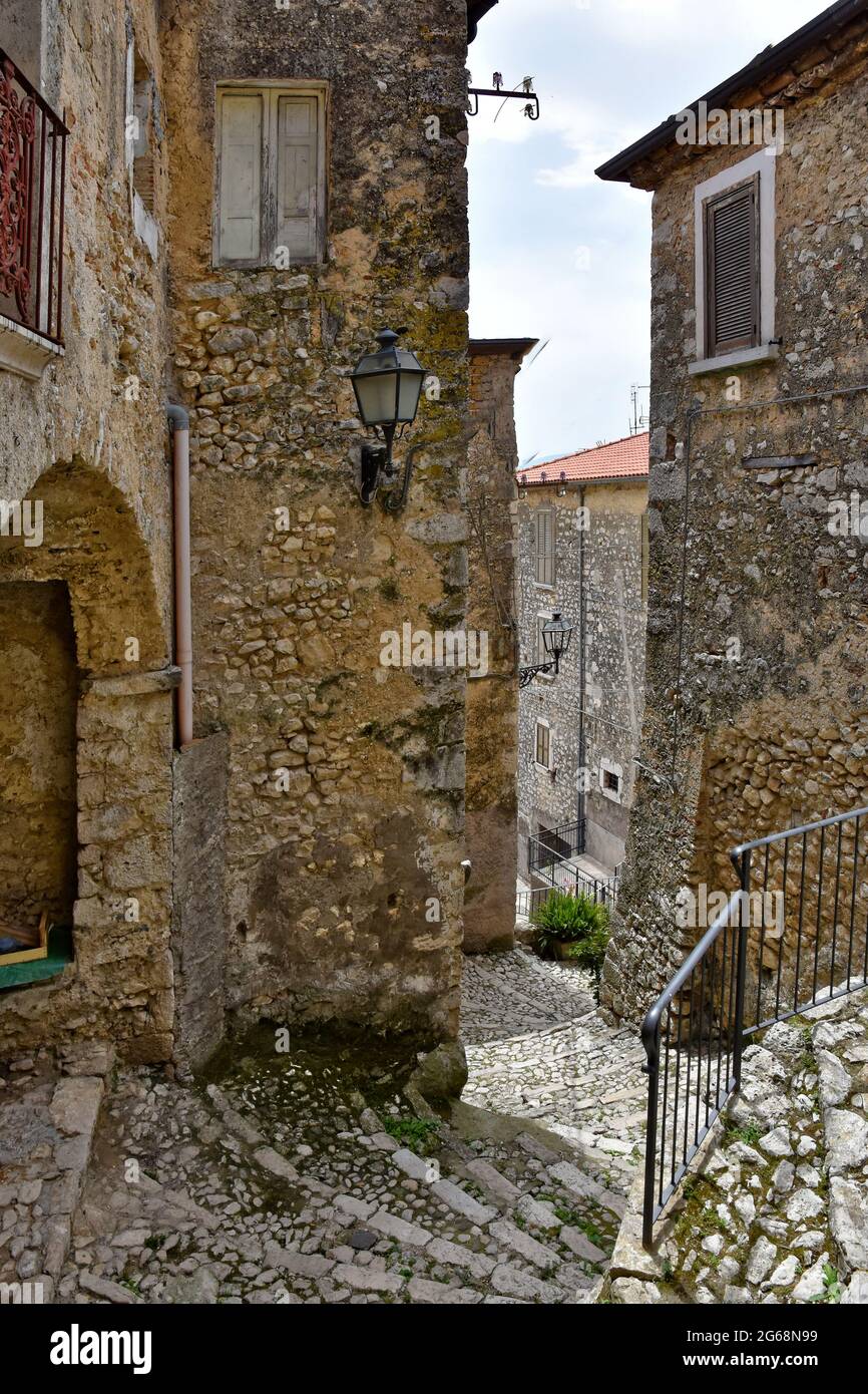 A narrow street between the old houses of Arce, a medieval village in ...