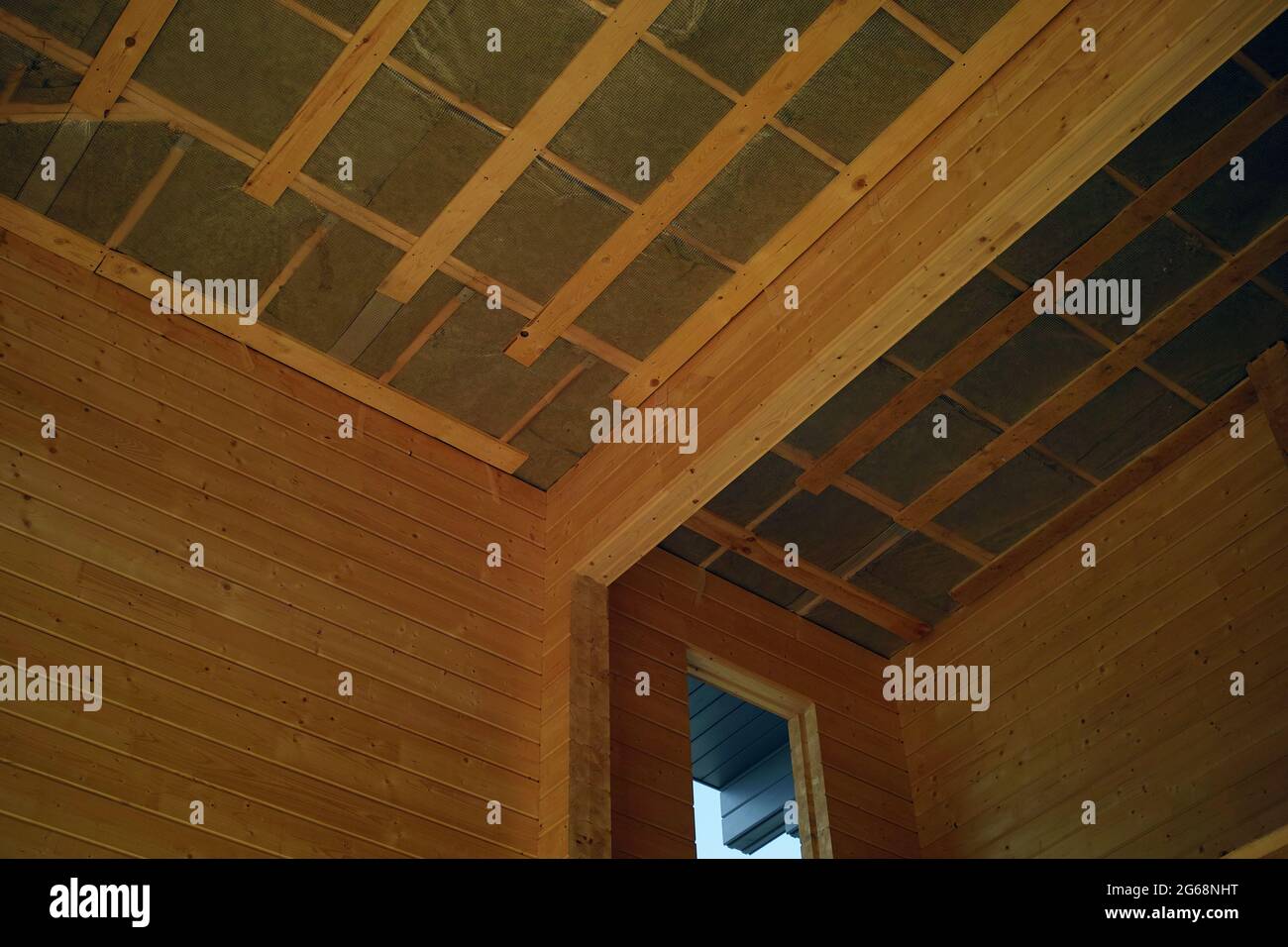 Insulating of a ceiling in wooden room or loft during construction ...