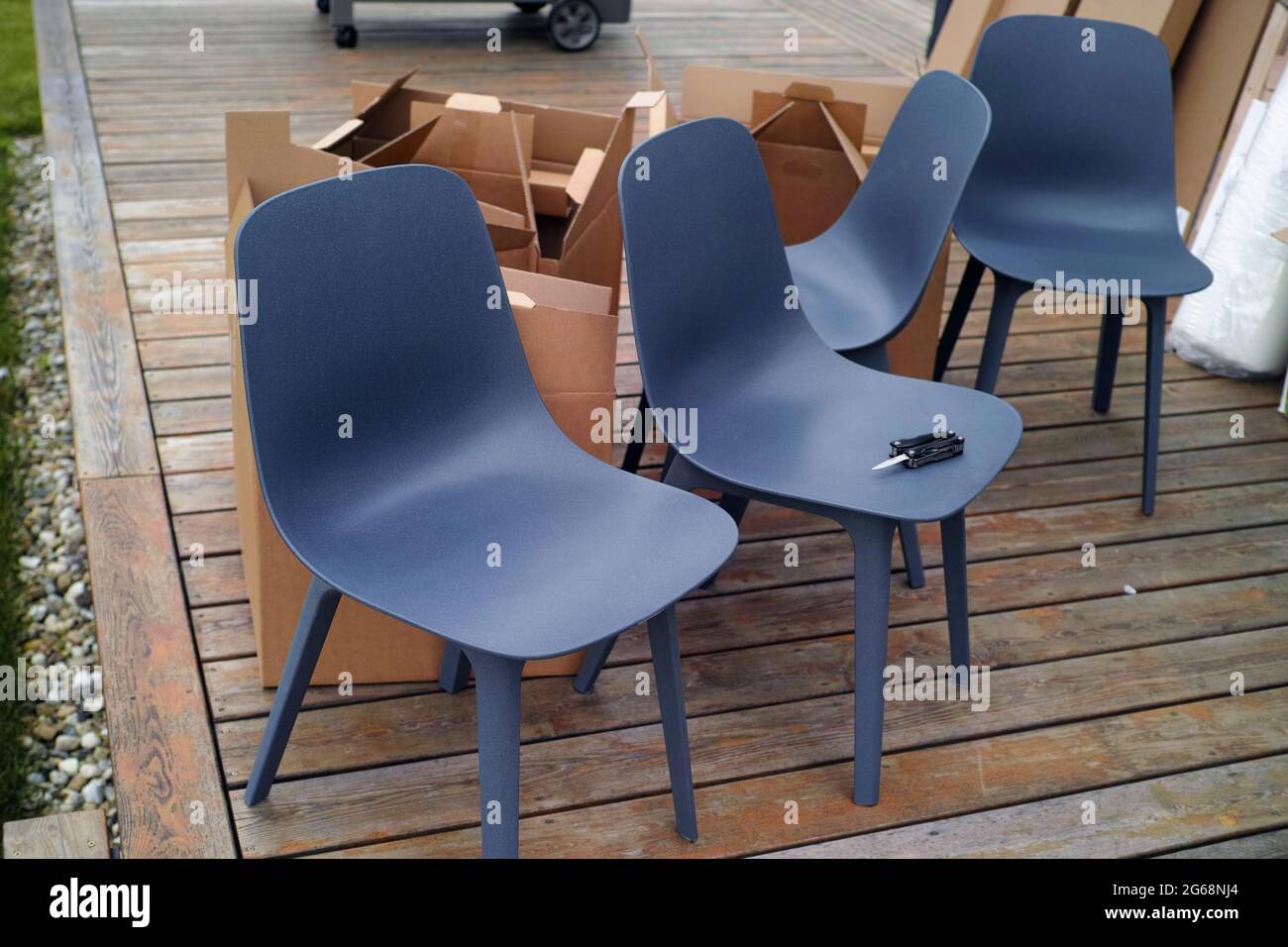 New plastic chairs assembling, a bunch of used cardboard boxes in the ...