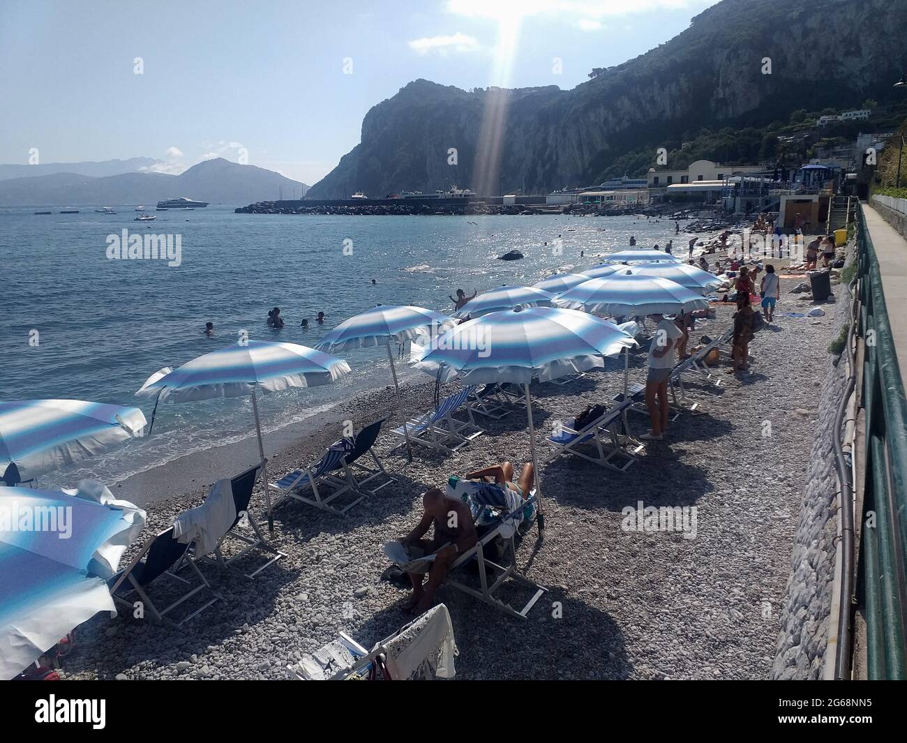 Summer: tourists and bathers on the Marina Grande beach in Capri island ...