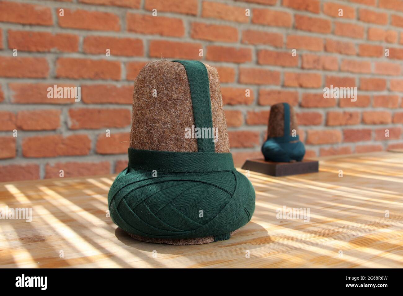 A hat made of felt worn by the whirling dervishes. The brown hat worn ...