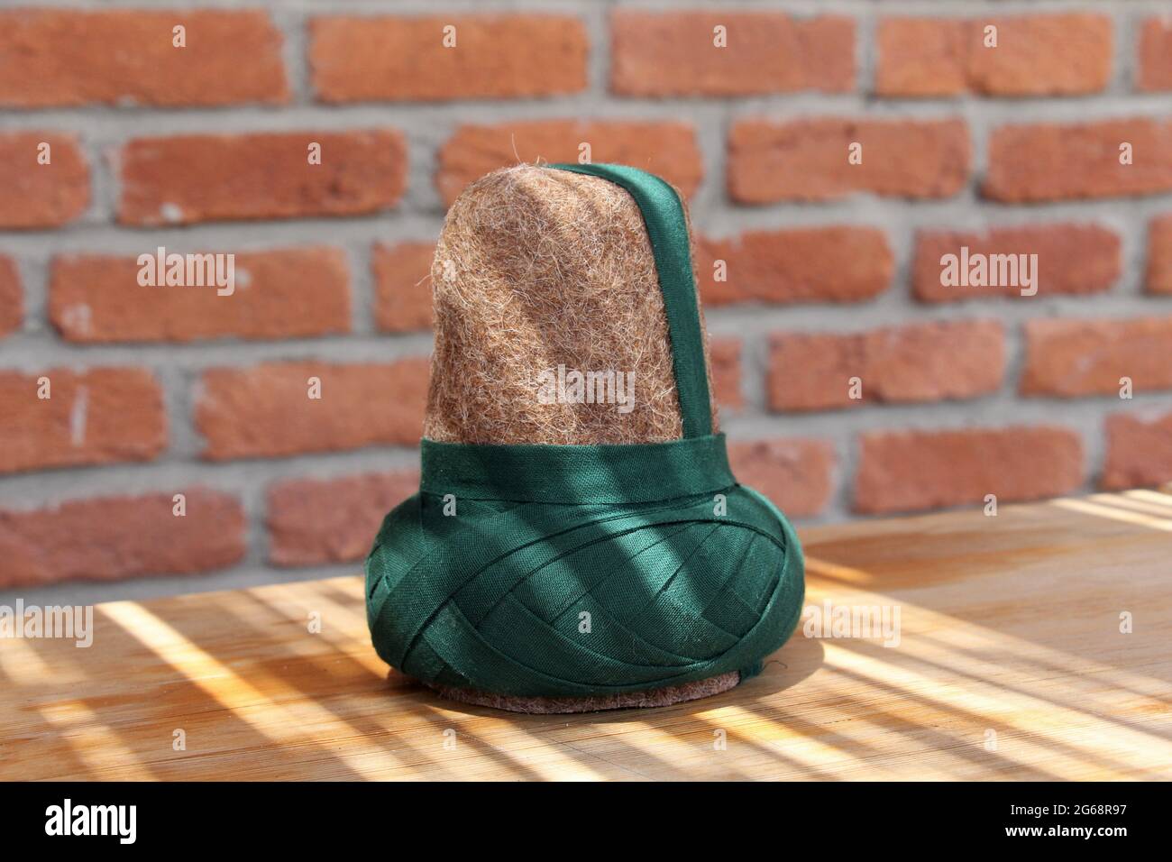 A hat made of felt worn by the whirling dervishes. The brown hat worn ...