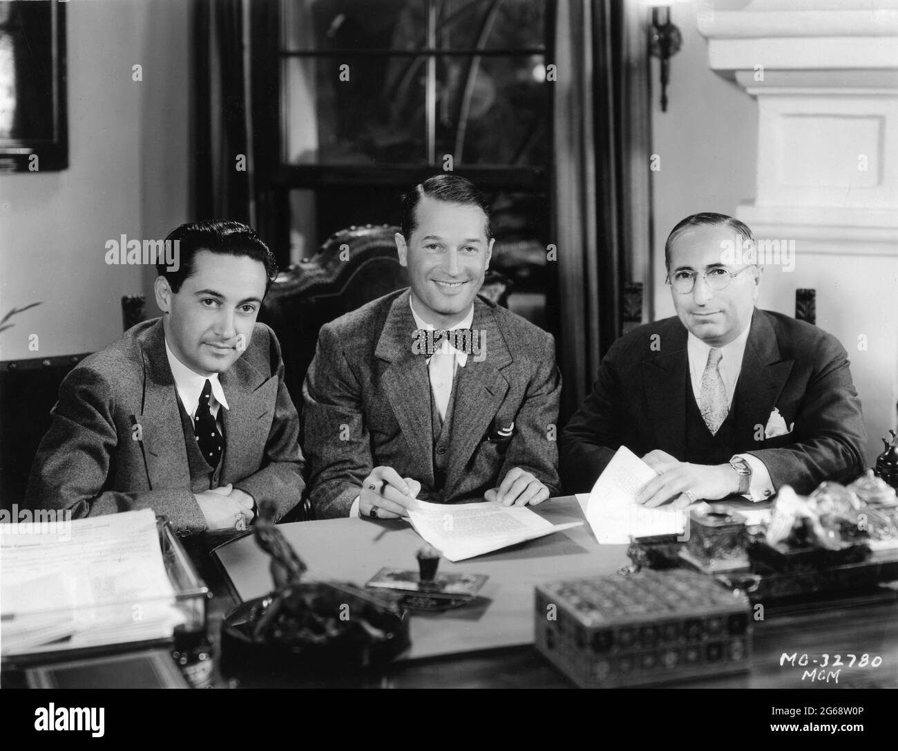 IRVING THALBERG and LOUIS B. MAYER look on in October 1933 as MAURICE ...