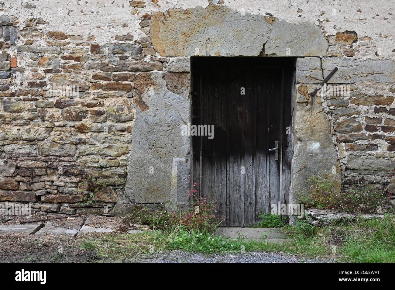 Rustic door of a historic sandstone barn of the monastery in Loccum ...
