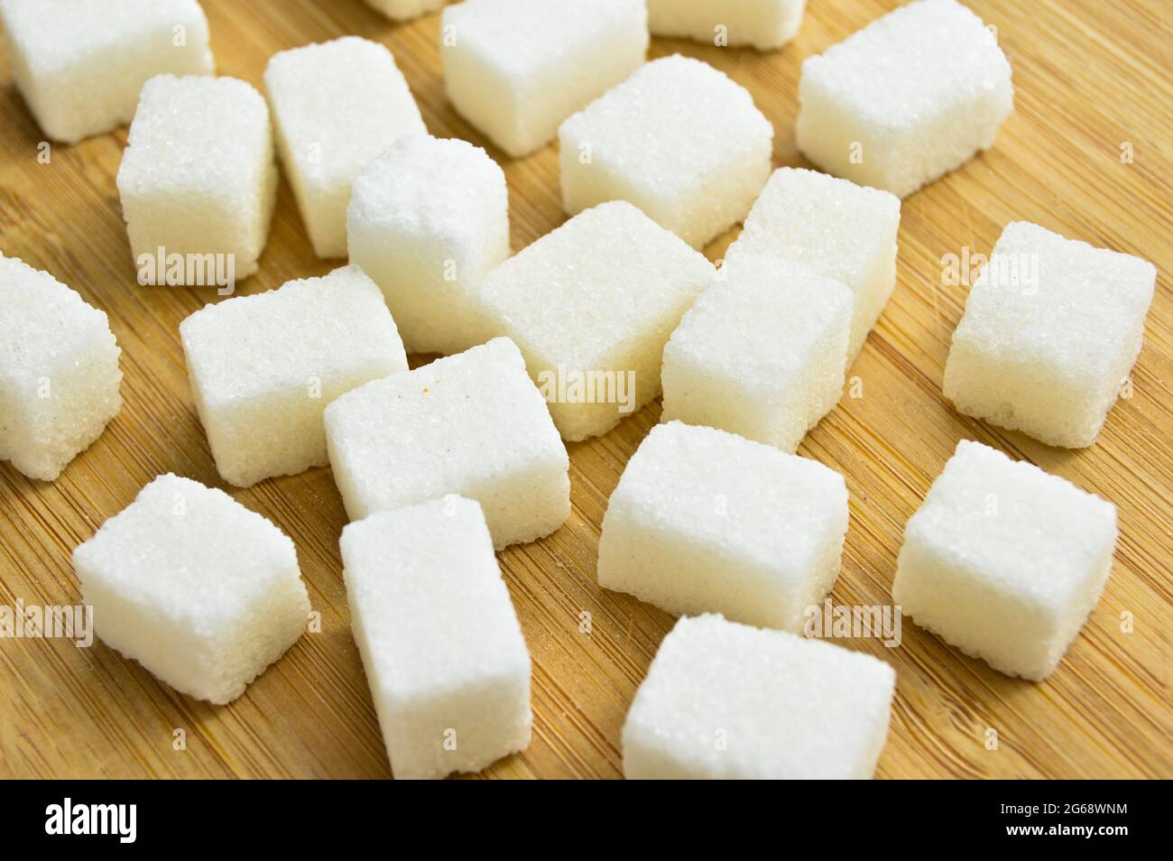 White and sugar cubes on bamboo cutting board sugar cubes texture Stock ...