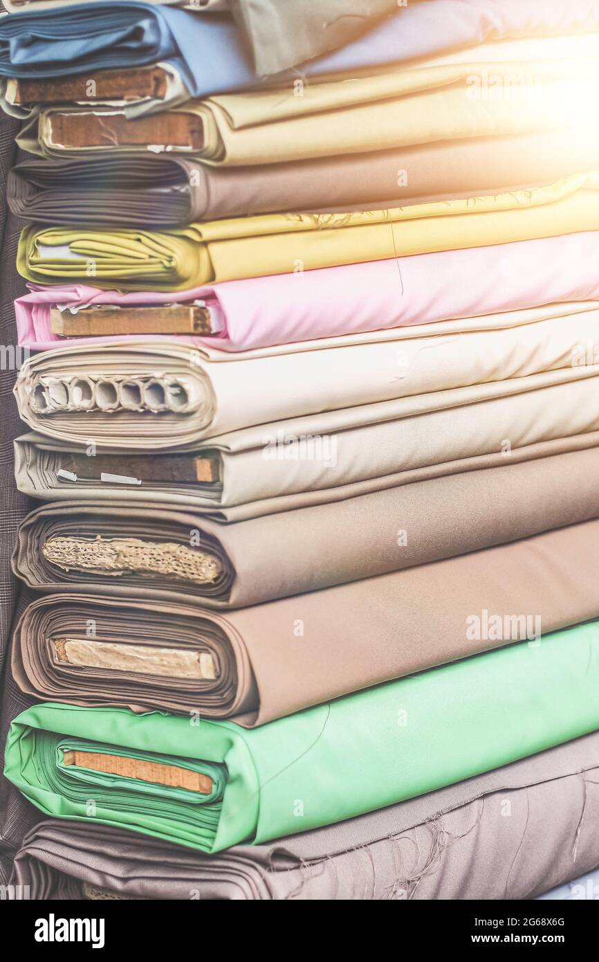 colorful fabric rolls in textile shop industry.Rolls of bright colored ...