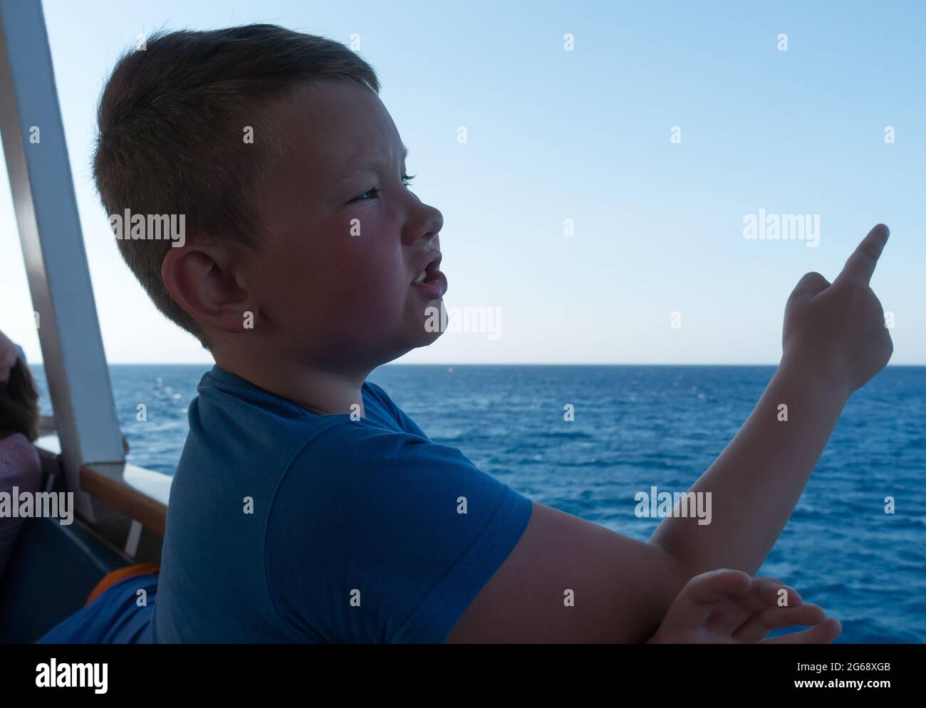 boy on a ship sets sail in the blue sea Stock Photo - Alamy