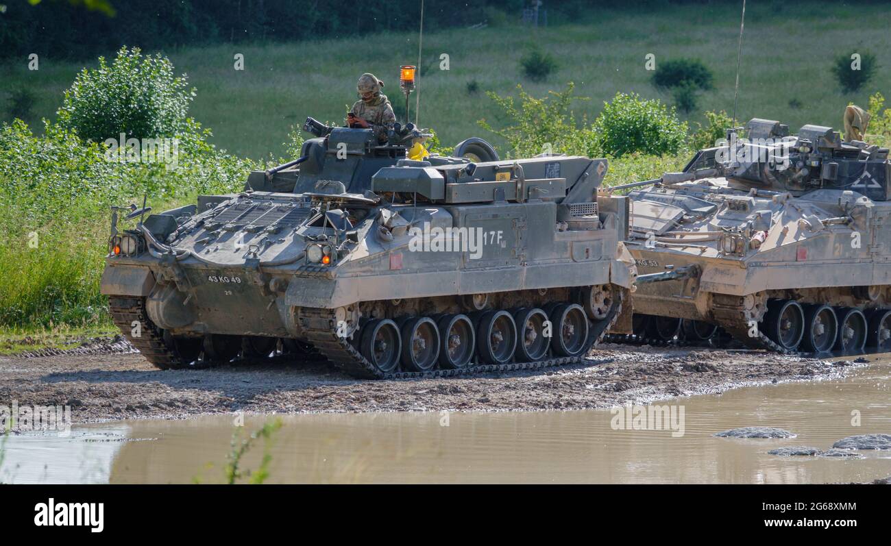 British army Warrior FV510 light infantry fighting vehicle tank being towed by a mechanized ...