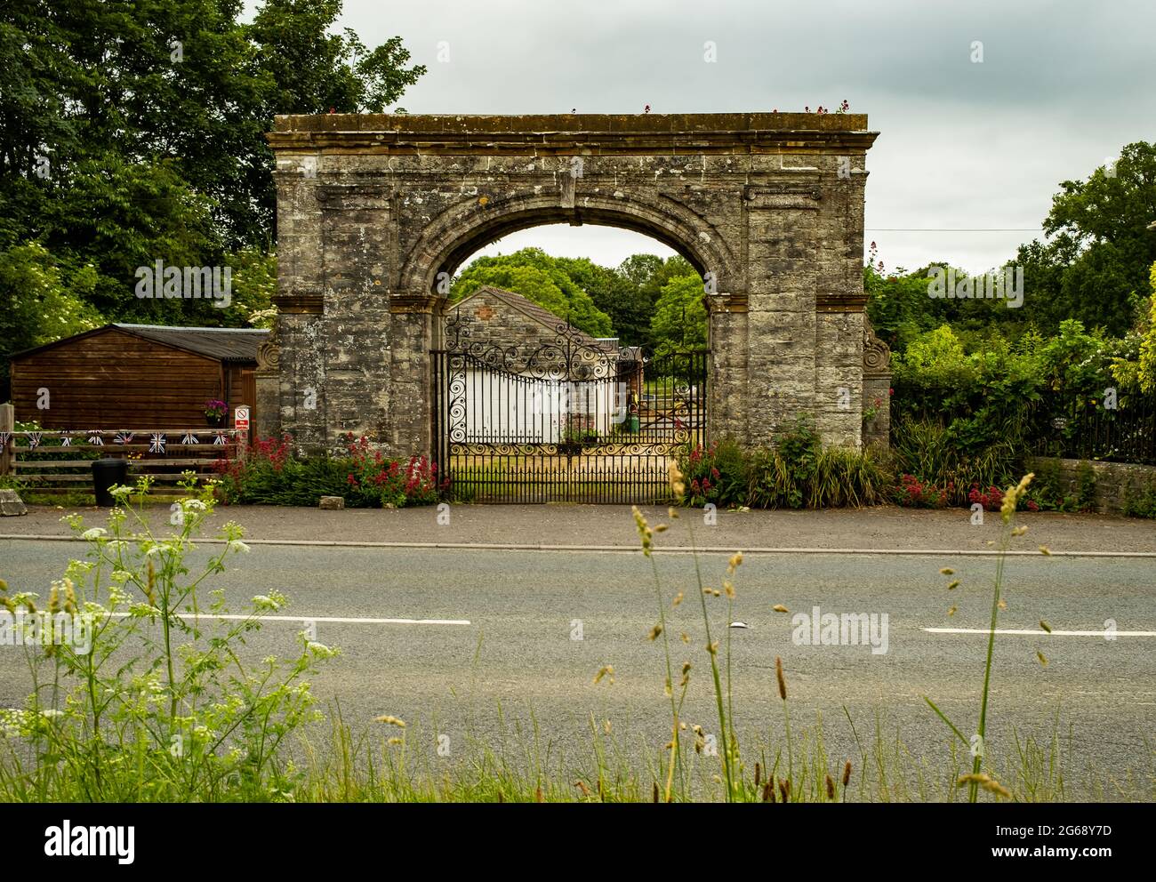 Historic stone arch at the entrance to an English country garden Stock ...