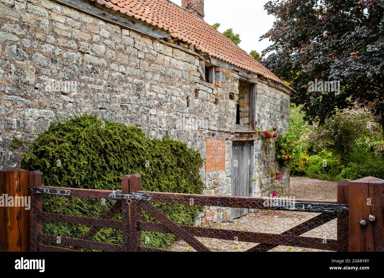 Old unidentifiable disused barn constructed from traditional stone ...