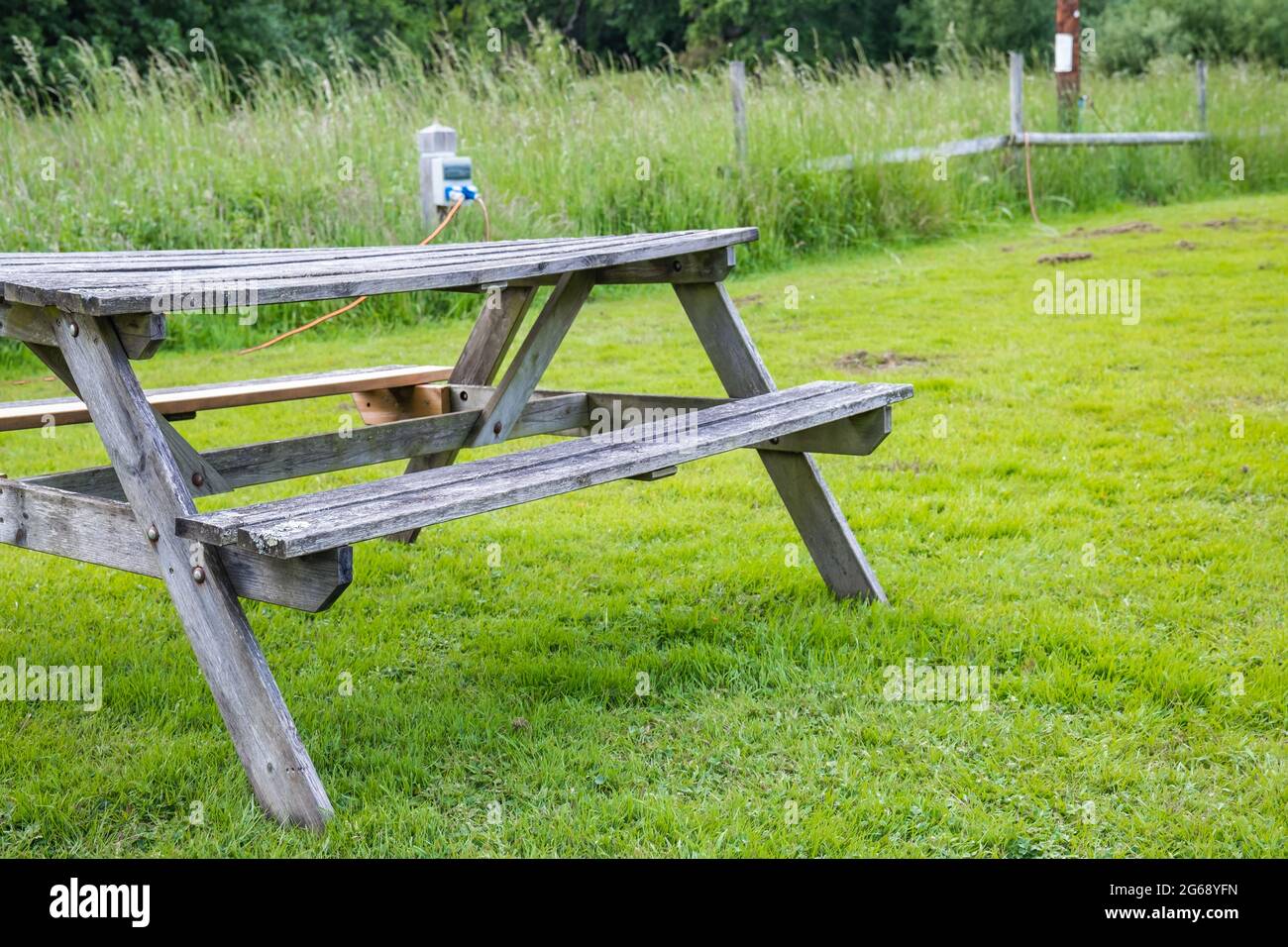 Close up of wooden bench on the grass in a UK campsite Stock Photo - Alamy