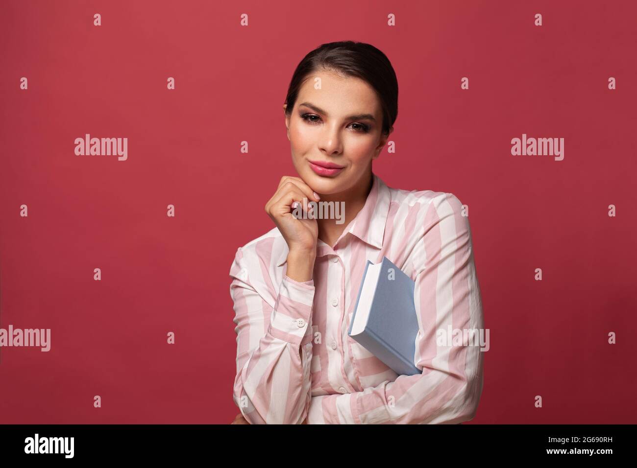Beautiful young woman on red banner background. People sincere emotions ...