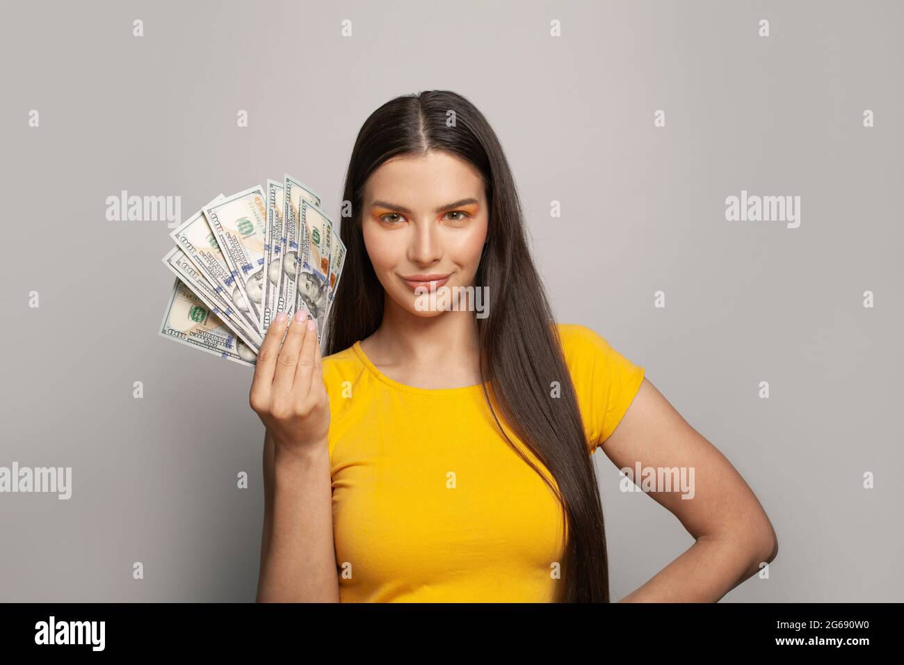 Pretty woman with American dollars cash money on white background ...