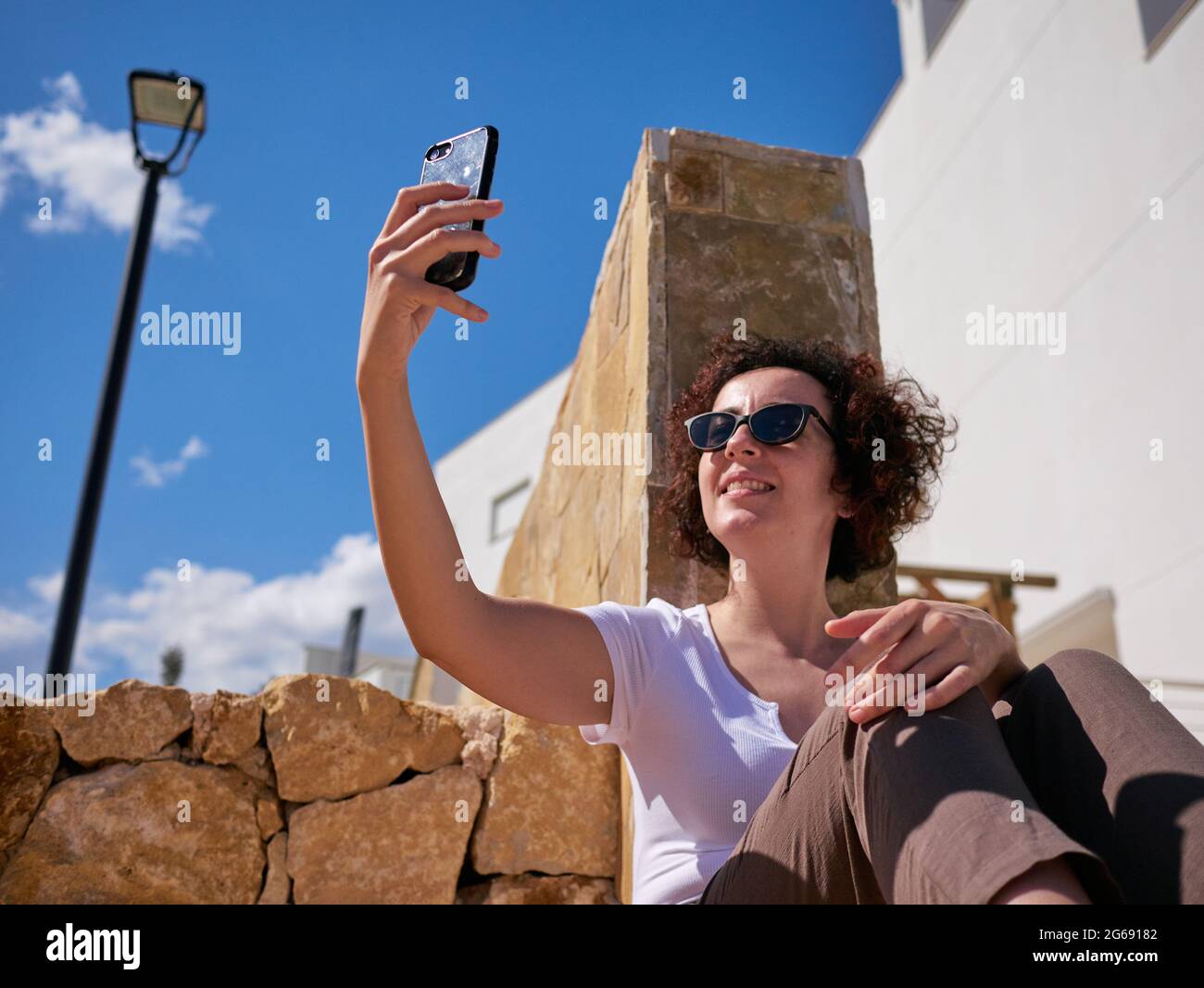 Woman taking a selfie with the phone outdoors Stock Photo - Alamy