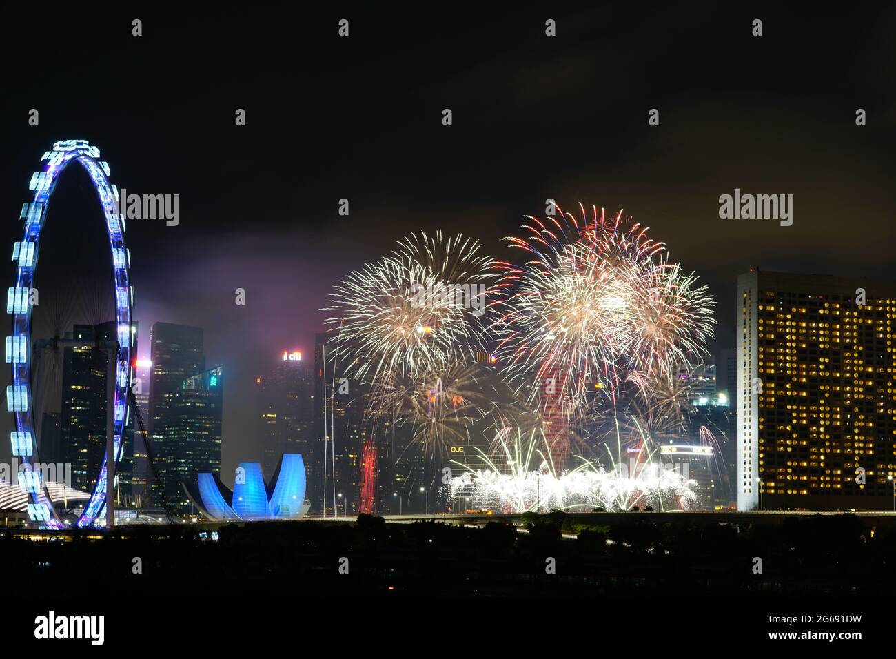 Firework with Singapore Flyer in background Stock Photo - Alamy