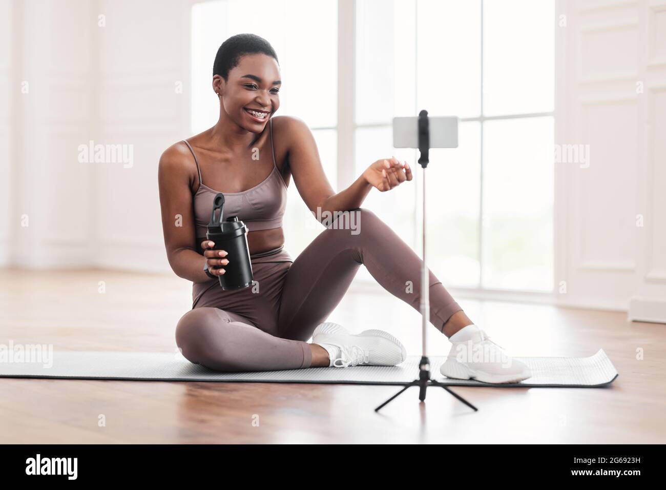 Young woman recording video blog on smartphone Stock Photo - Alamy