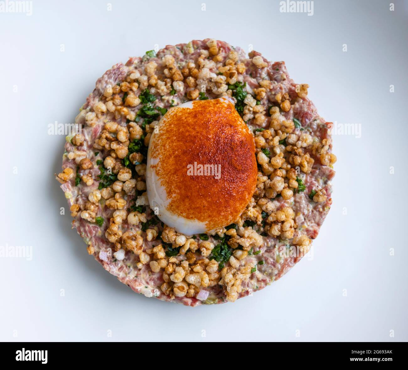 Steak tartare, a meat dish made from raw ground (minced) beef, seasoned ...