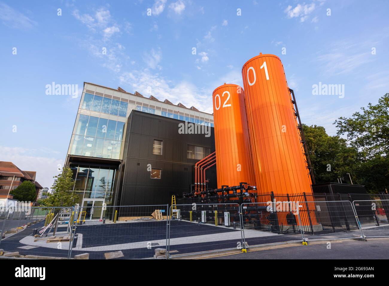 2 large orange storage containers outside a new modern office block ...