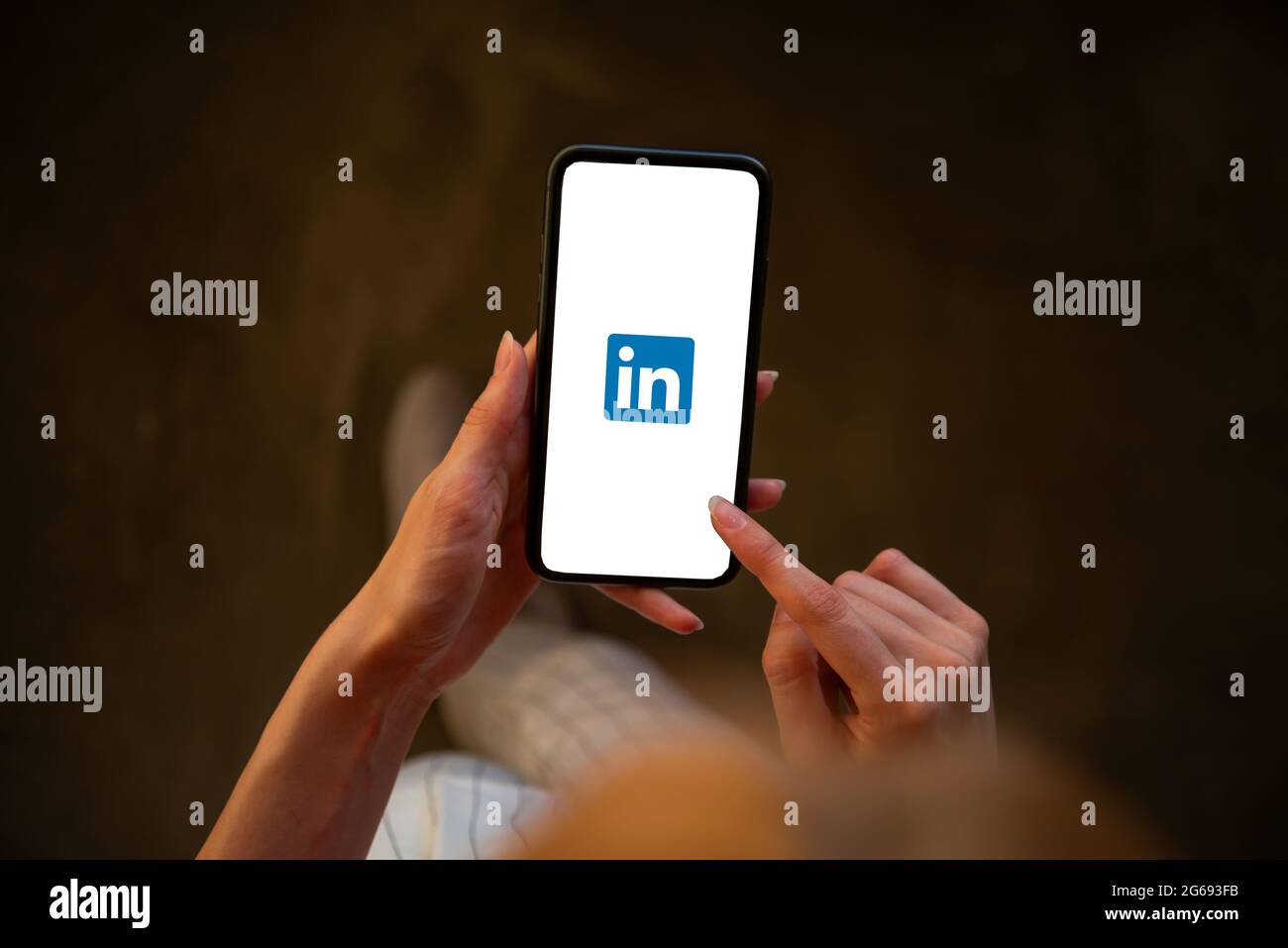 Riga, Latvia - July 3, 2021: Woman holding mobile phone with LinkedIn ...