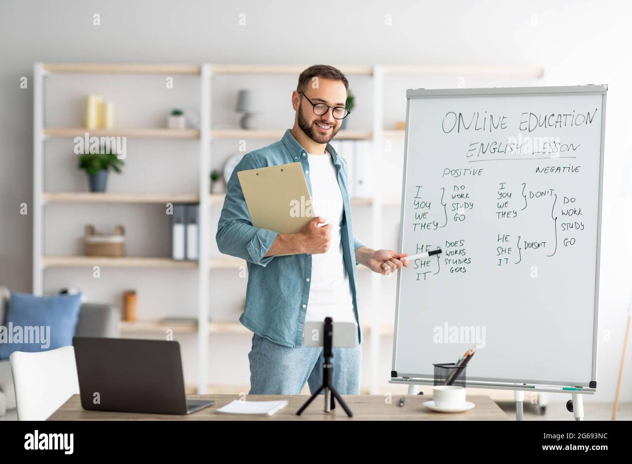 Distance learning and online tutoring. Confident male teacher giving ...