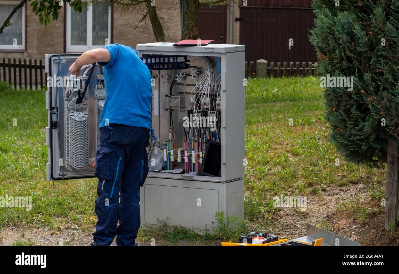 Worker and fiber optic cable lines installation at street Stock Photo ...