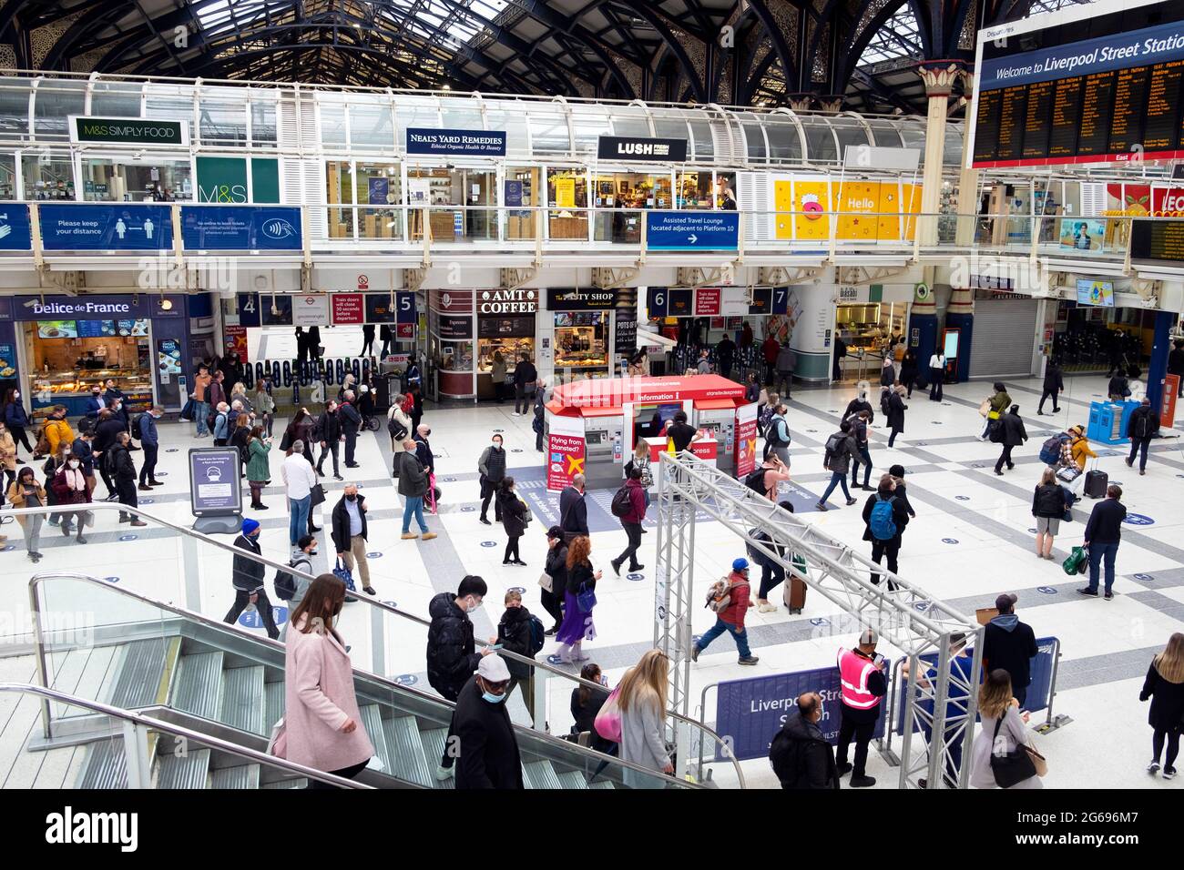 People passengers walking on the concourse and checking departure times ...