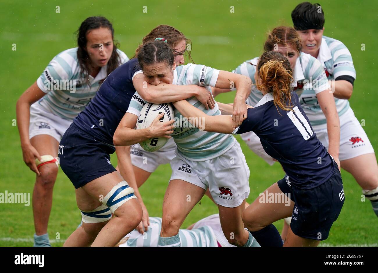 Cambridge's Colette Russell (centre) tackled by Oxford's Hannah Cooper ...