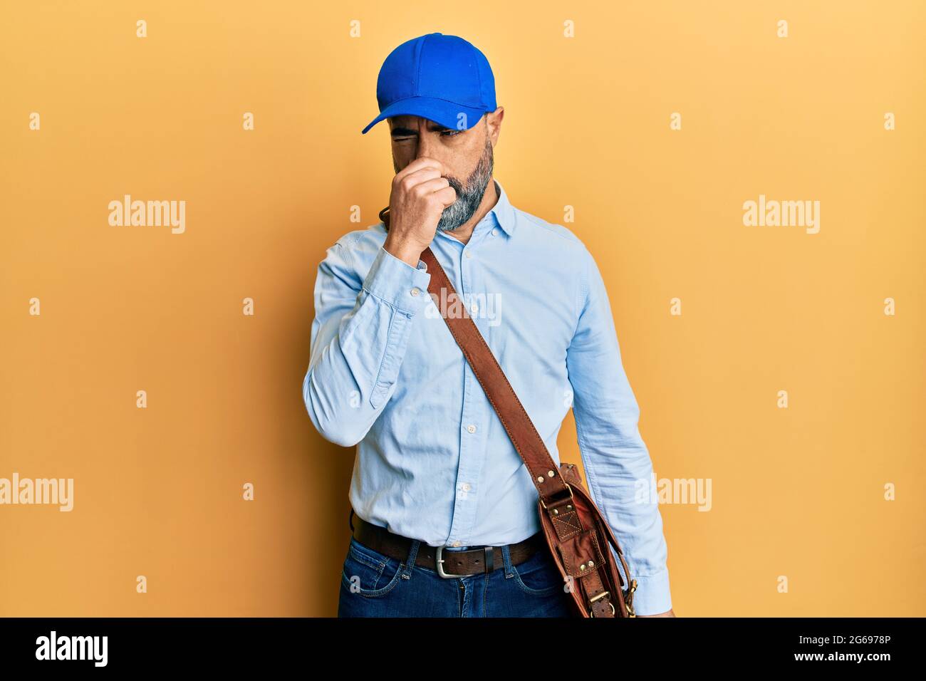Middle age man with beard and grey hair wearing delivery courier cap ...