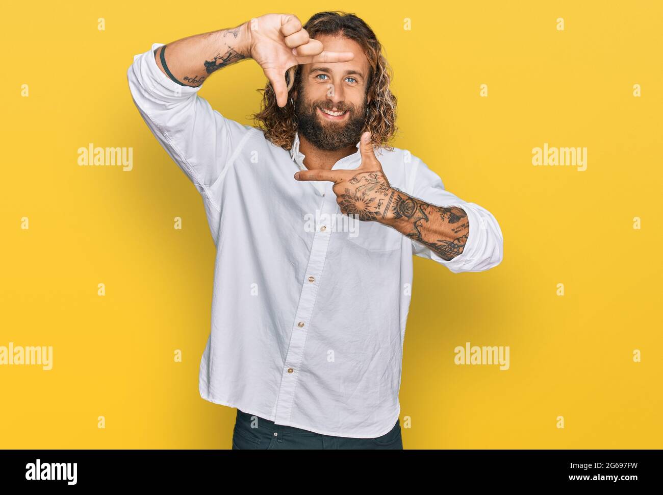 Handsome man with beard and long hair wearing casual clothes smiling ...